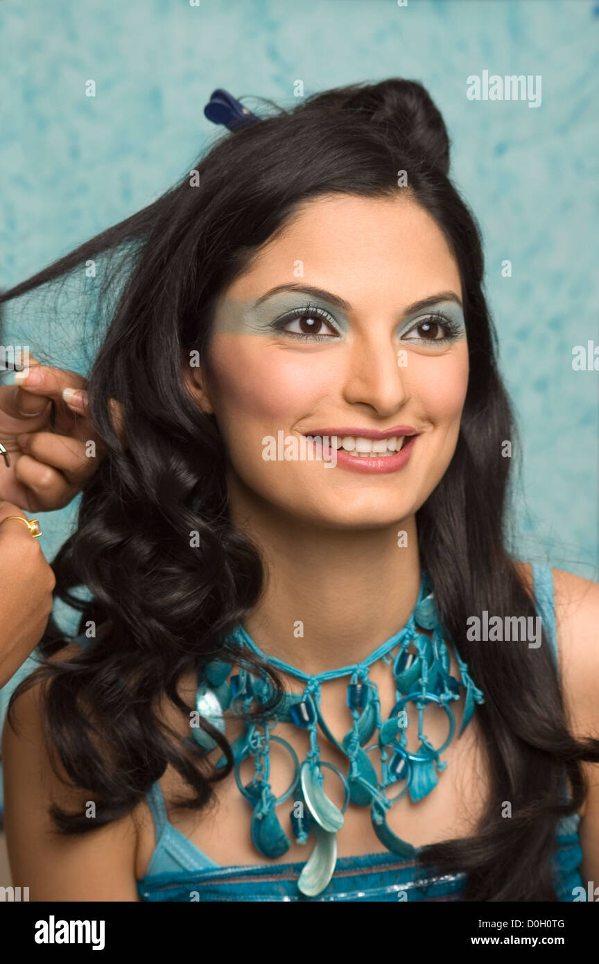 Person's hand styling a young woman's hair Stock Photo - Alamy