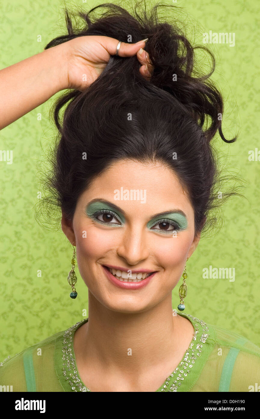 Person's hand styling a young woman's hair Stock Photo - Alamy