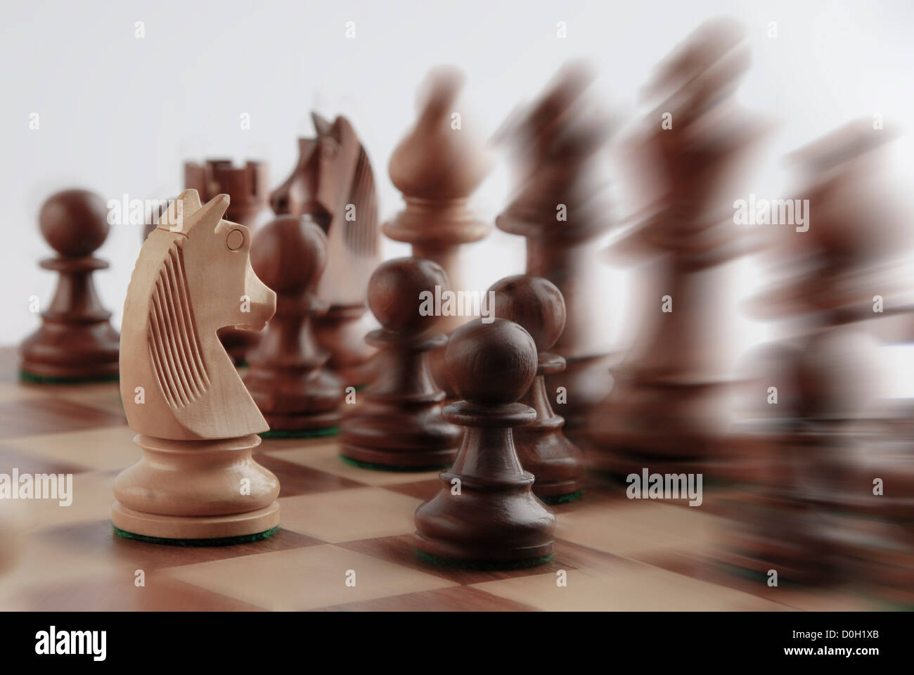 White knight facing black chess pieces Stock Photo - Alamy