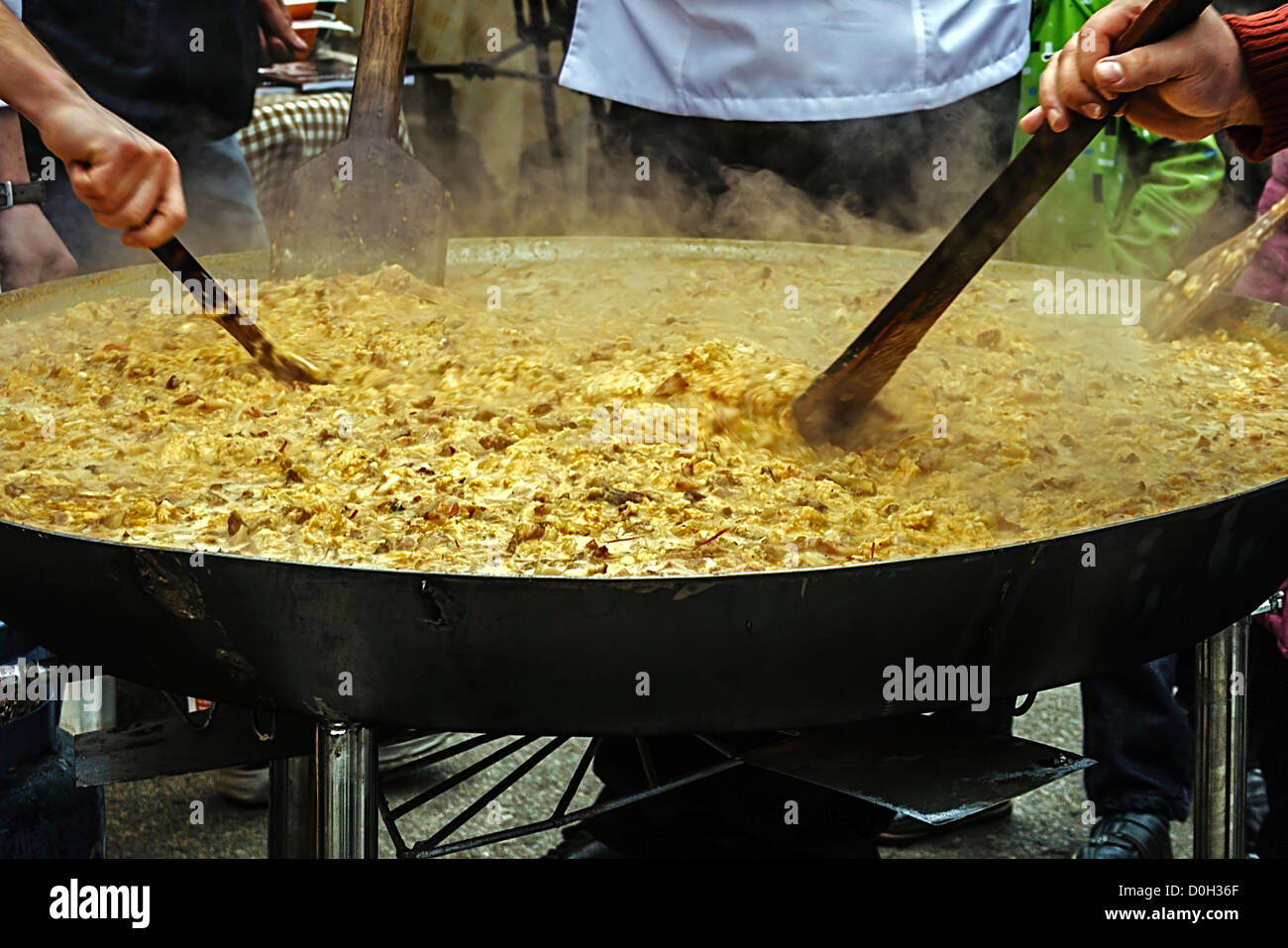 Giant omelet from 1000 eggs, prepared and mixed with wooden utensils by ...