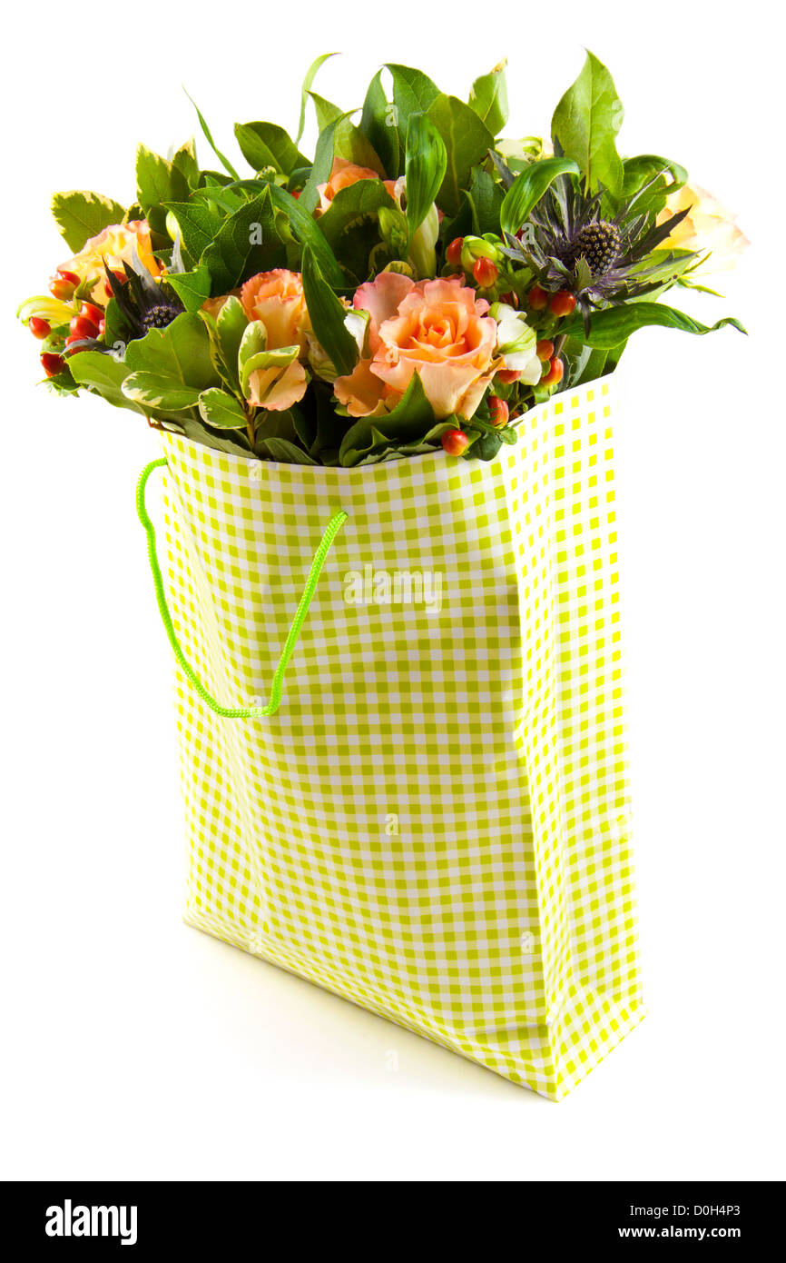 Bouquet with different kind of flowers in a bag isolated over white ...