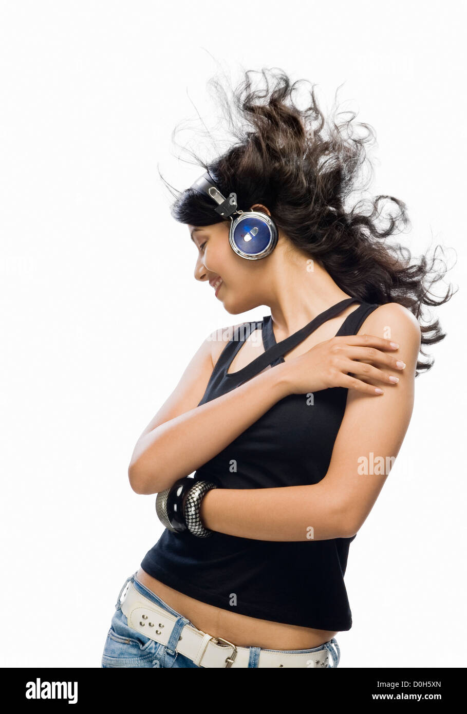Young woman listening to music and dancing Stock Photo - Alamy