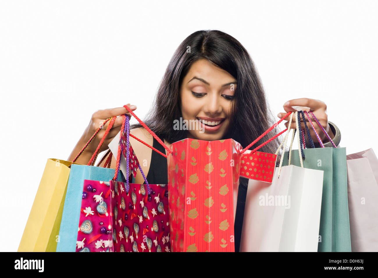 Young woman looking into a shopping bag Stock Photo - Alamy