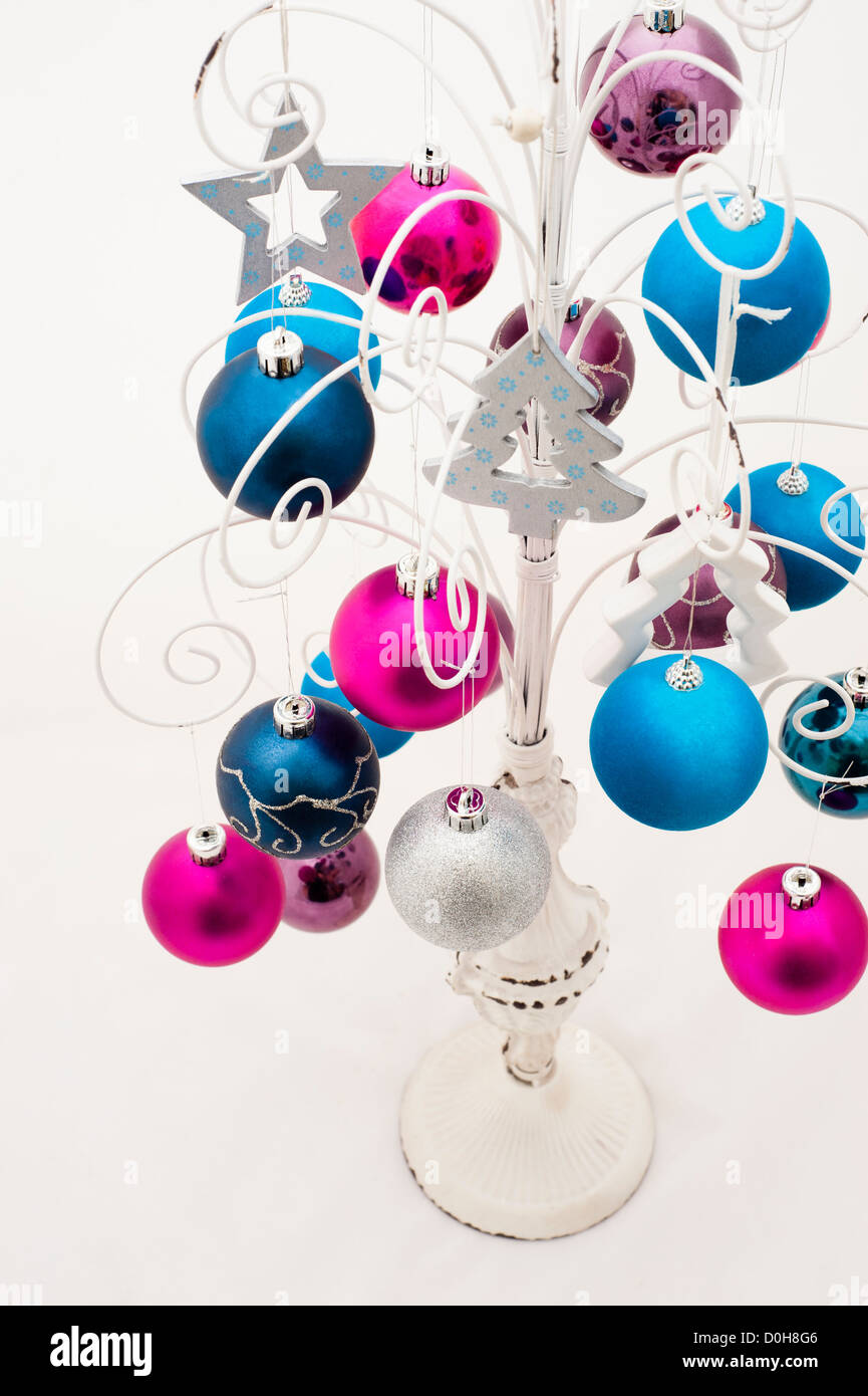 Brightly coloured Christmas decorations and baubles hanging from a ...