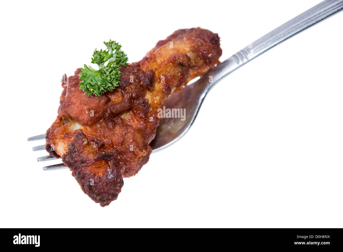 Chicken Wing on a fork isolated on white background Stock Photo - Alamy