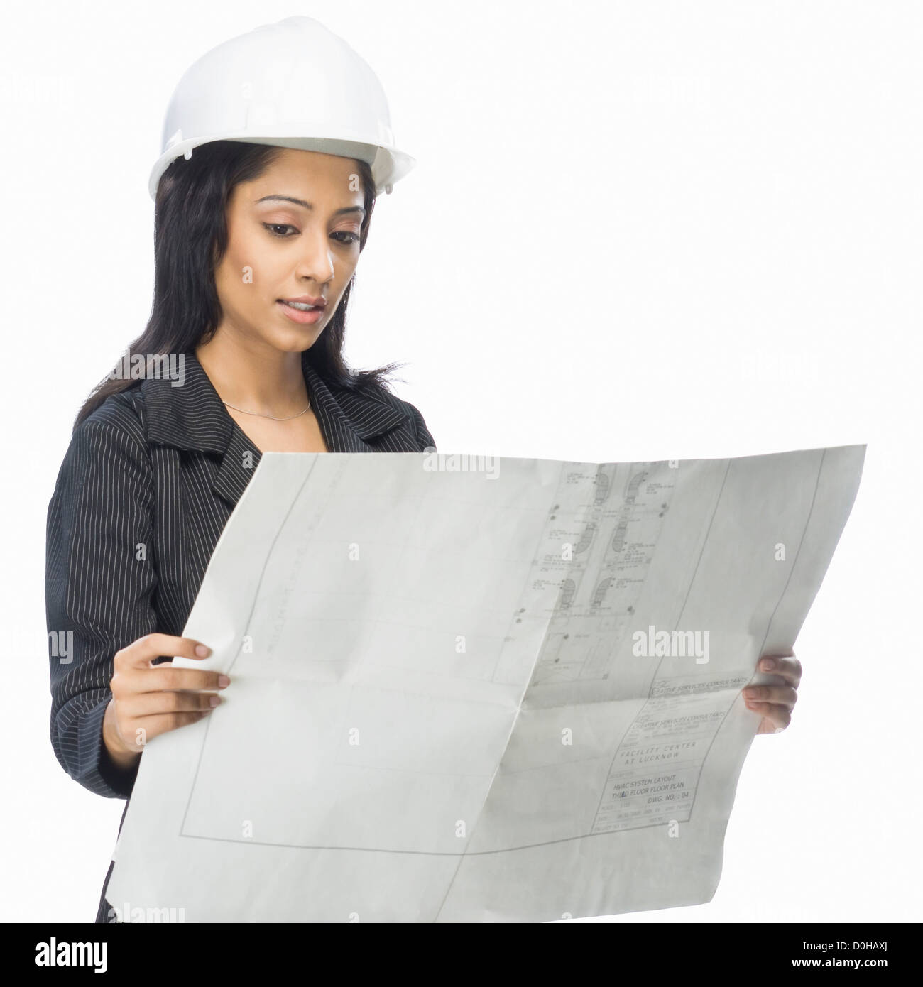 Female architect looking at a blueprint Stock Photo - Alamy