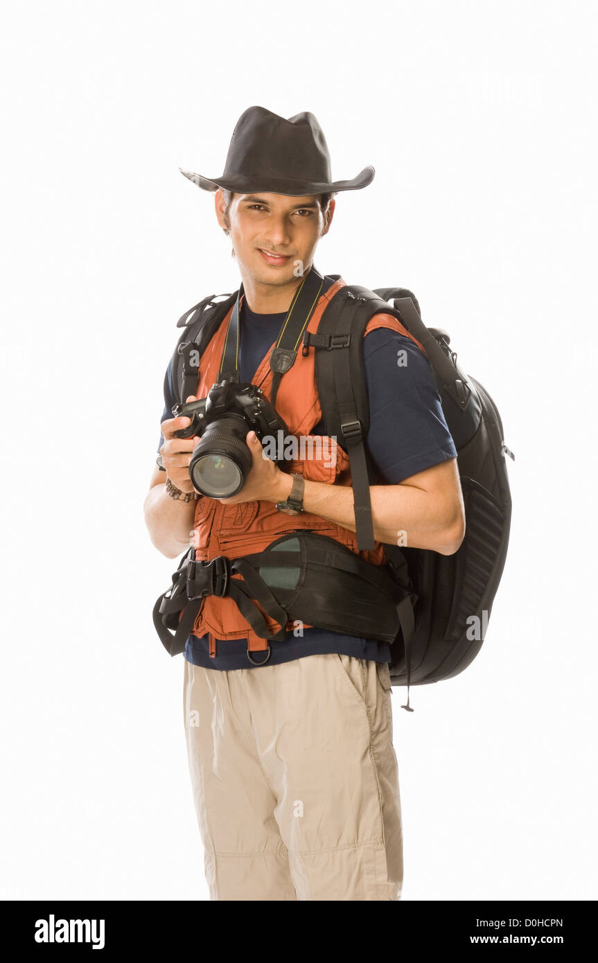 Portrait of a young male photographer holding a digital camera Stock ...