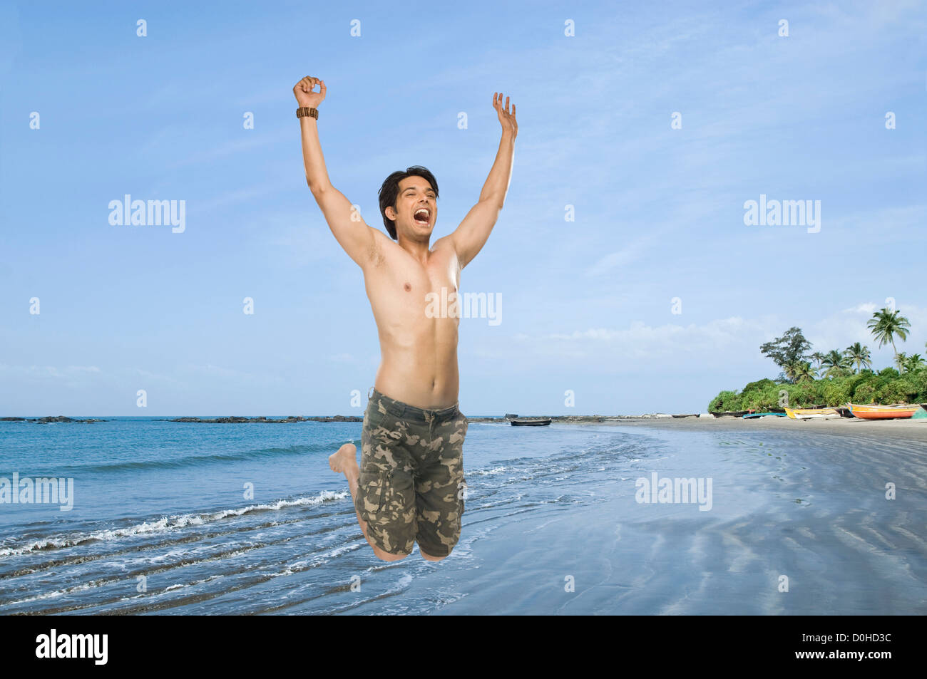 Young man jumping with joy Stock Photo - Alamy