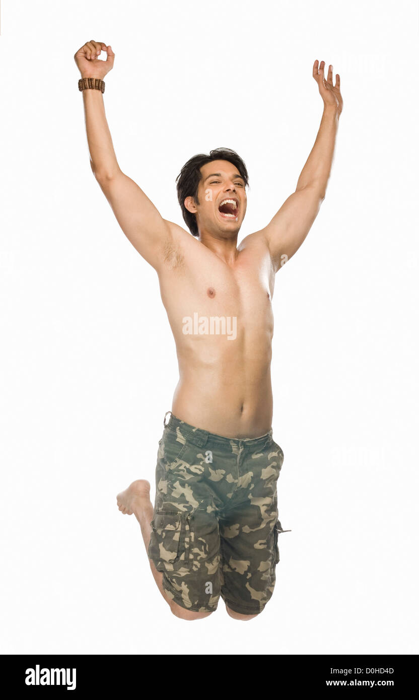 Young man jumping with joy Stock Photo - Alamy