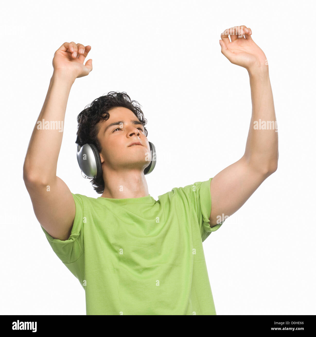 Man listening to music with his hands raised Stock Photo - Alamy