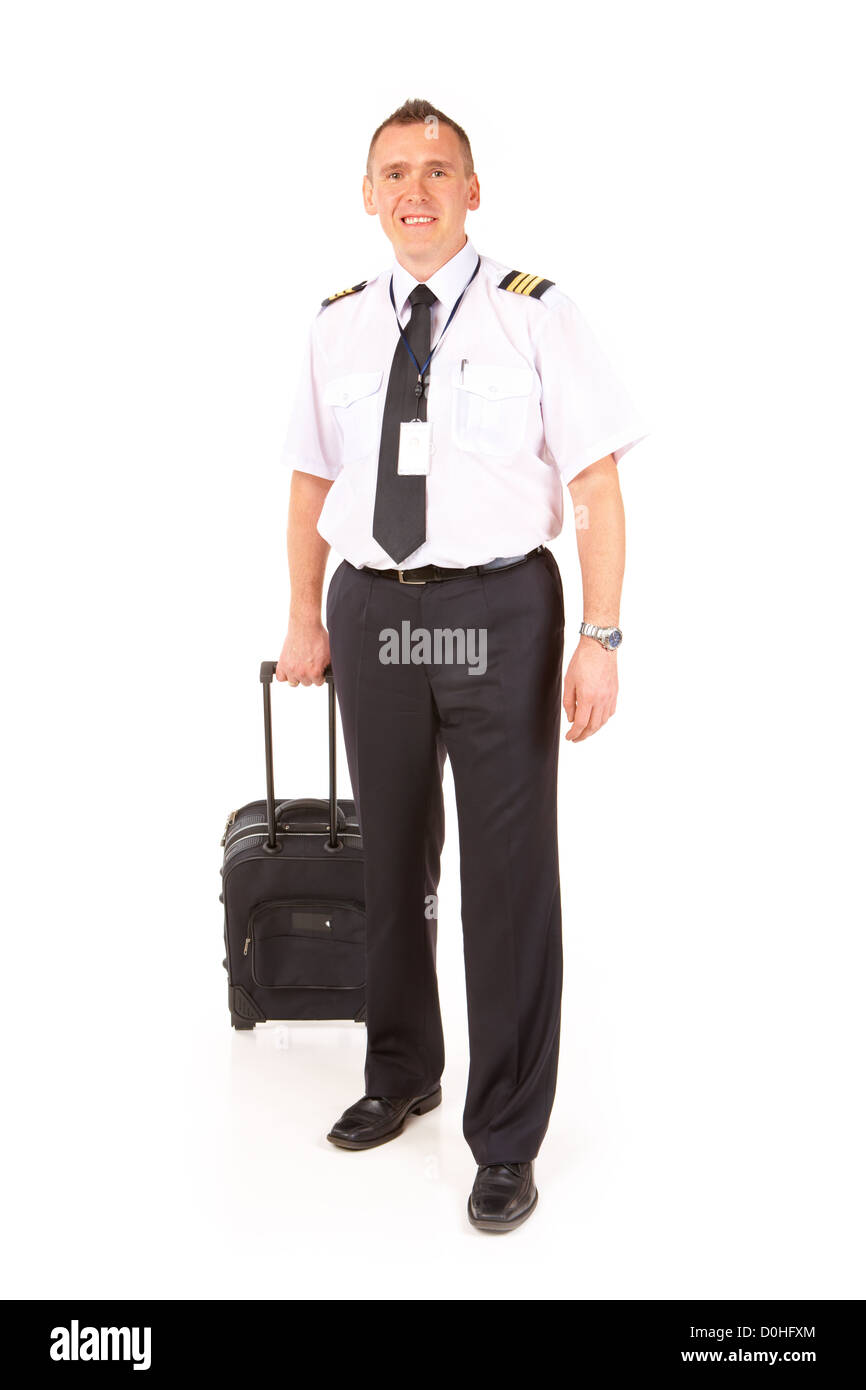 Cheerful pilot wearing uniform with epaulettes standing with trolley ...