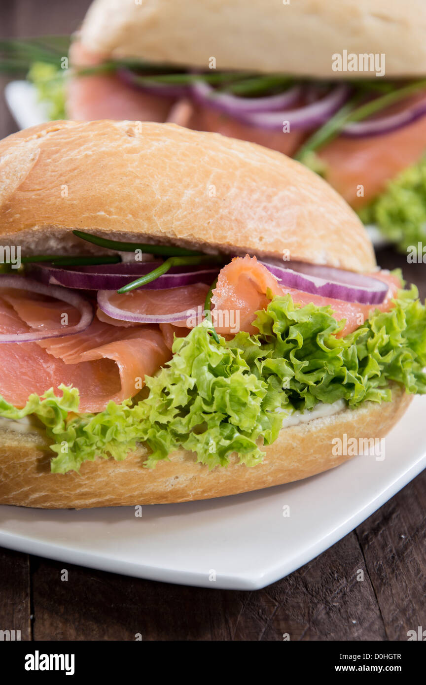 Bun with smoked Salmon on wooden background Stock Photo - Alamy