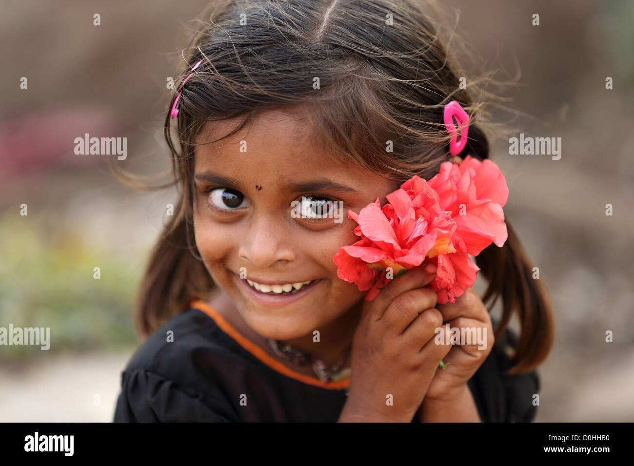 Indian girl holding flowers hi-res stock photography and images - Alamy