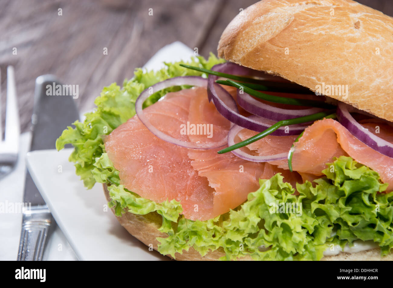 Salmon Bun on a plate against wooden background Stock Photo - Alamy