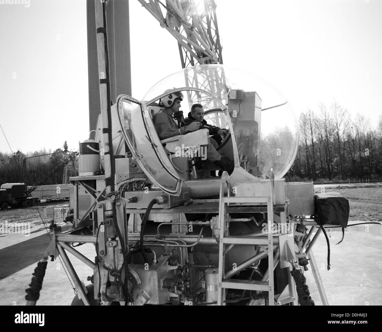 Astronaut Roger B. Chaffee (left) receives instruction from Maxwell W ...