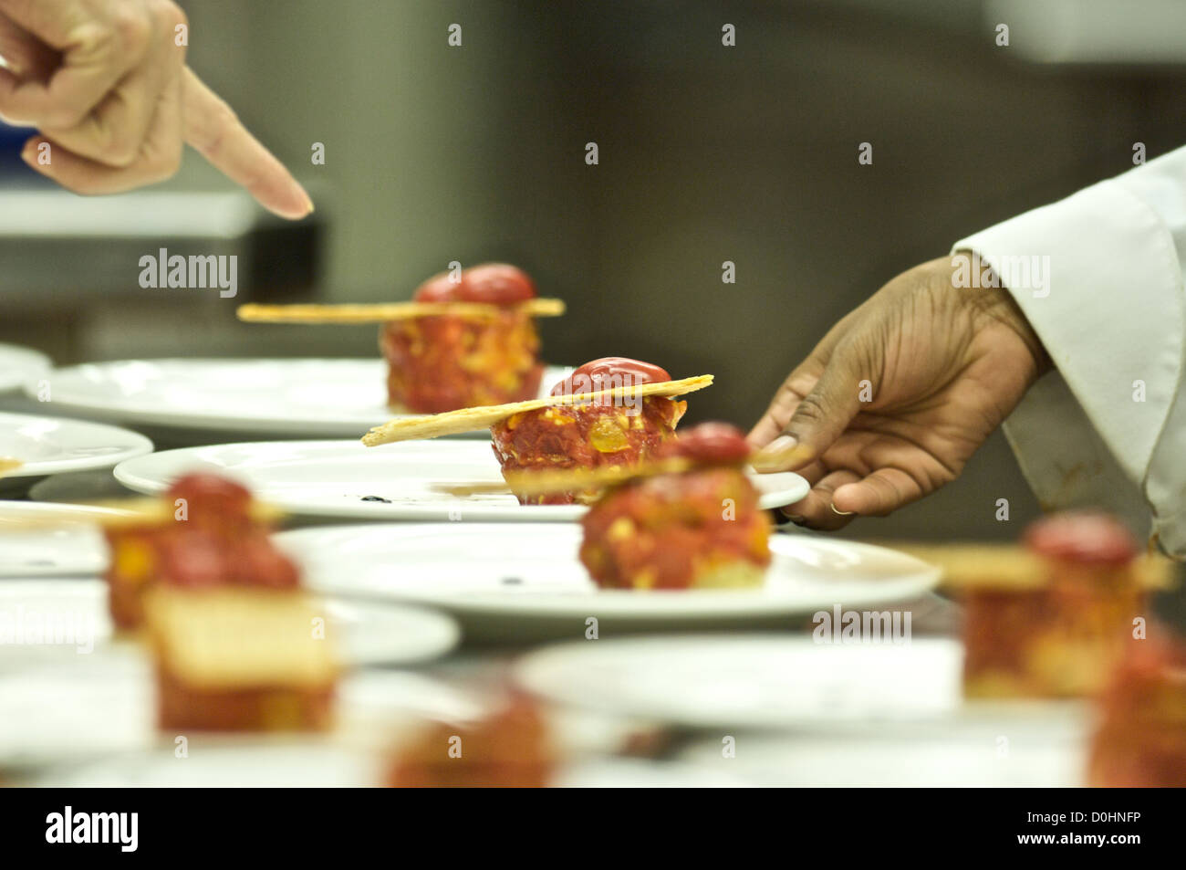 Hand pointing main dish in kitchen Stock Photo - Alamy