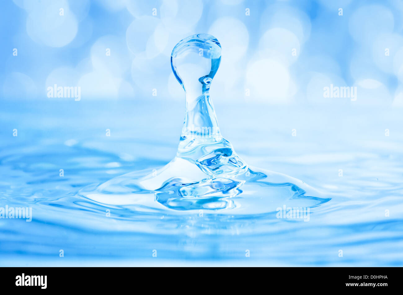 beautiful splash of water blue drops with blue lights in the background ...