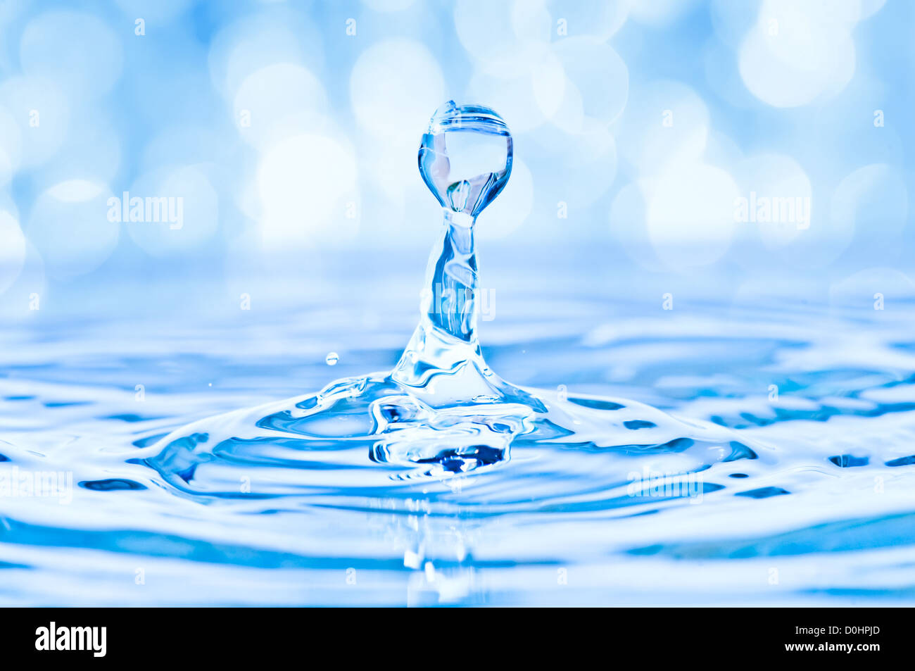 beautiful splash of water blue drops with blue lights in the background ...