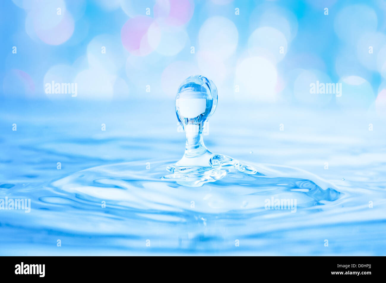 beautiful splash of water blue drops with blue lights in the background ...