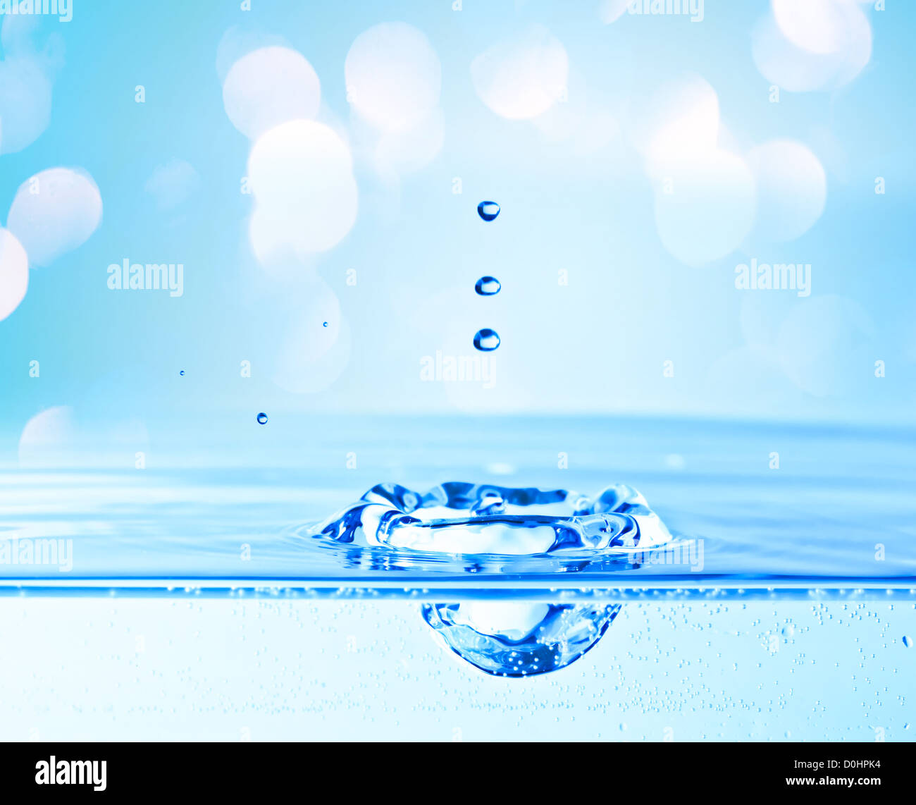 beautiful splash of water blue drops with blue lights in the background ...