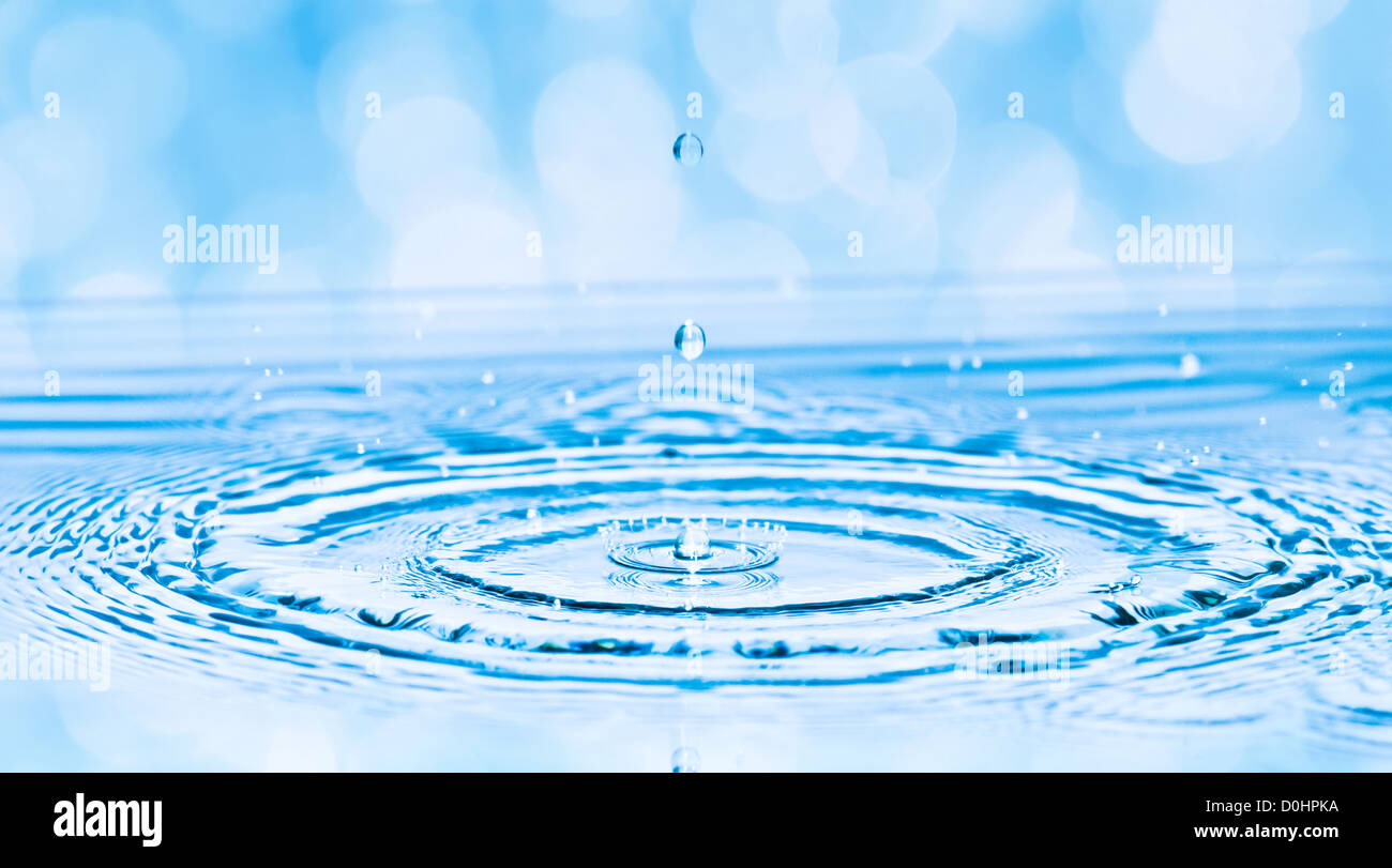 beautiful splash of water blue drops with blue lights in the background ...