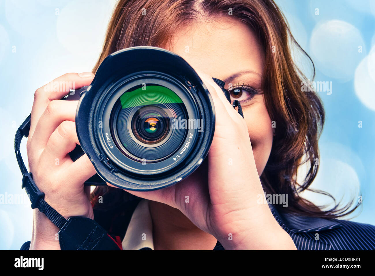 young girl with photocamera with blue lights in the background Stock ...