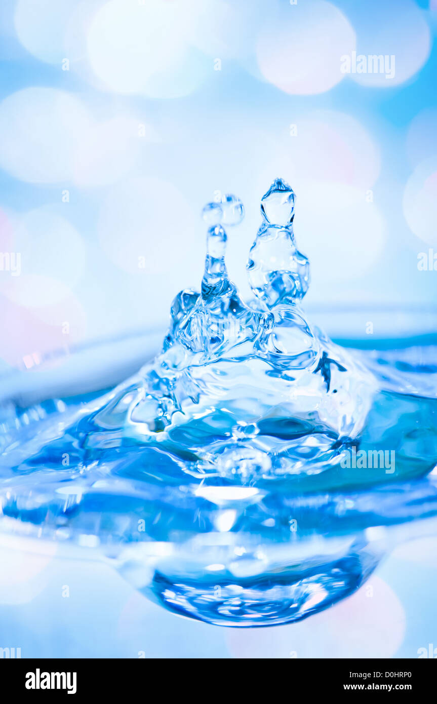 beautiful splash of water blue drops with blue lights in the background ...