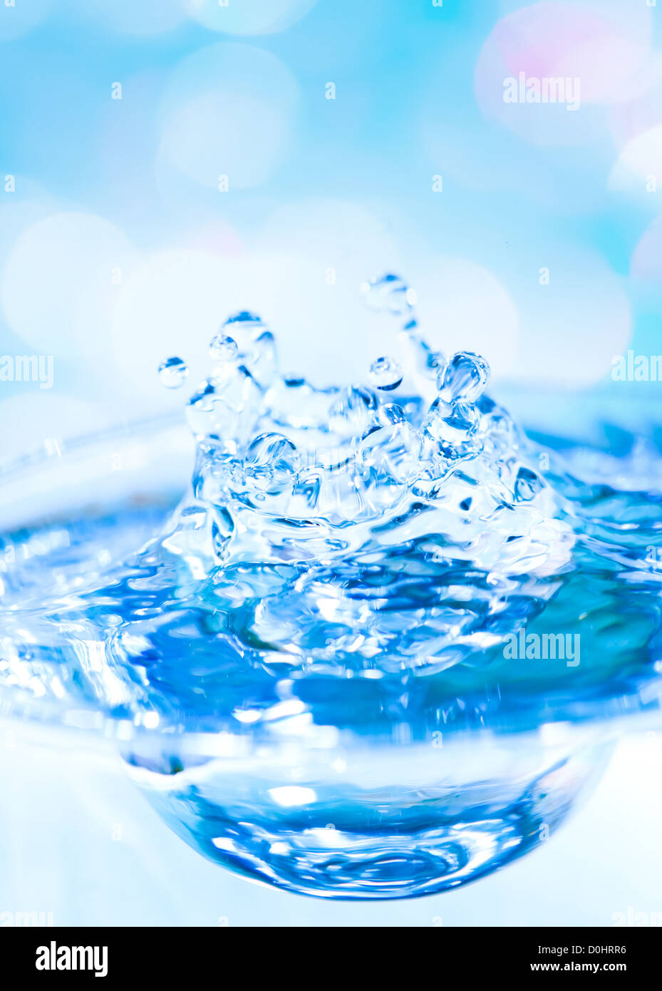beautiful splash of water blue drops with blue lights in the background ...