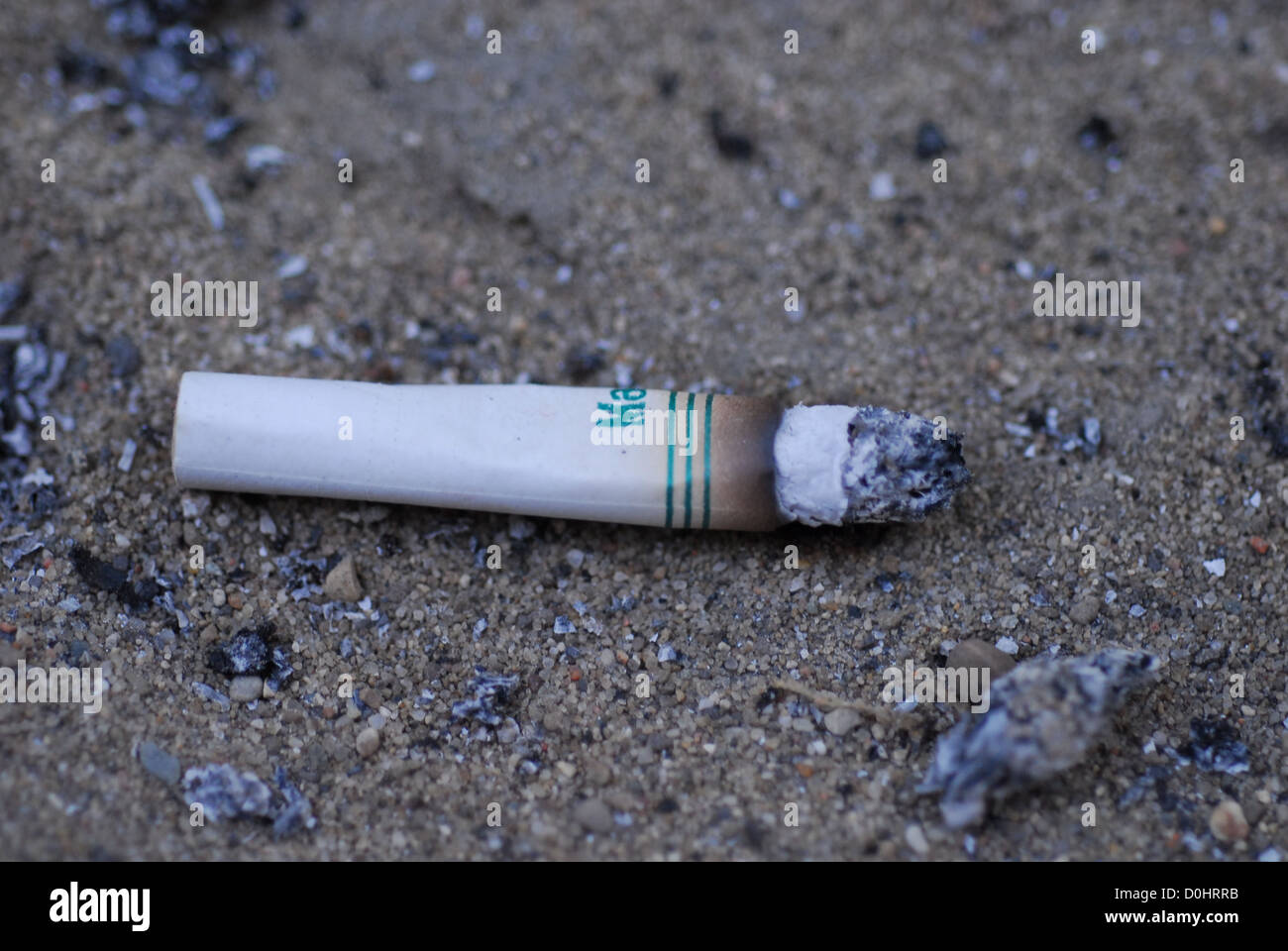 Discarded cigarettes in the street Stock Photo - Alamy