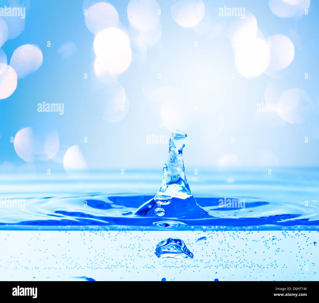 beautiful splash of water blue drops with blue lights in the background ...