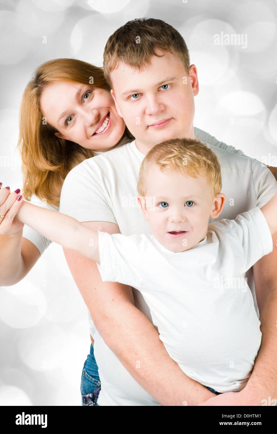 Portrait young family with lights in the background Stock Photo - Alamy