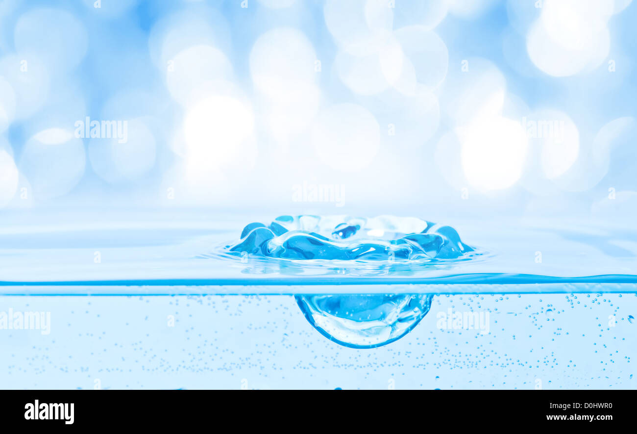 beautiful splash of water blue drops with blue lights in the background ...
