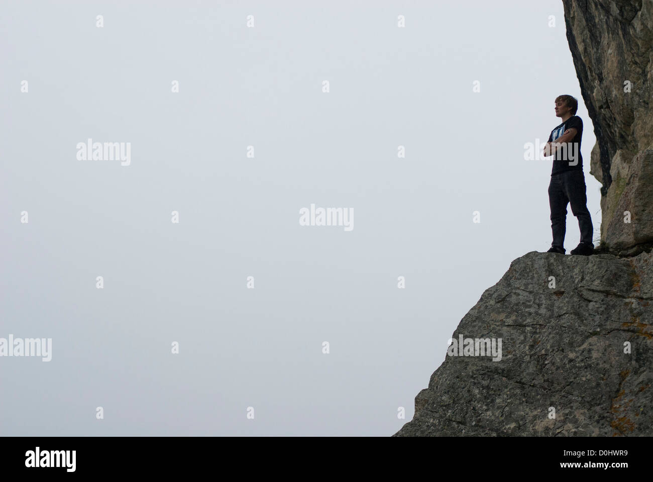 man standing edge cliff mountains Stock Photo - Alamy