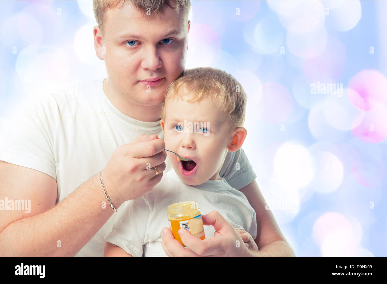 man feeding baby with a spoon Stock Photo - Alamy