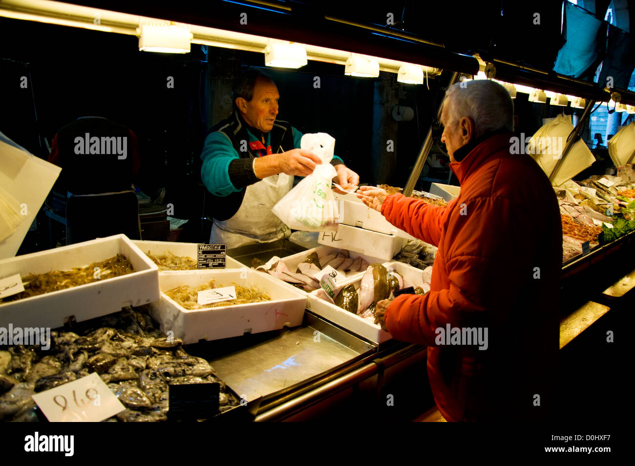 Man buys fish from a market stall at the Fish Market in Venice Stock ...
