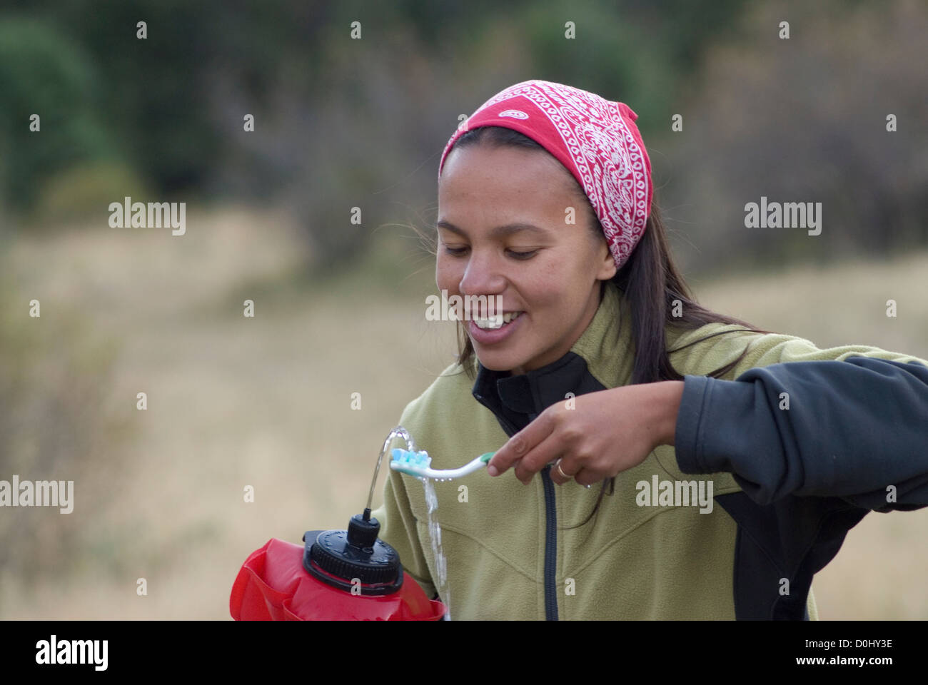 Woman brushing teeth on a backpack trip in Oregon's Wallowa Mountains ...