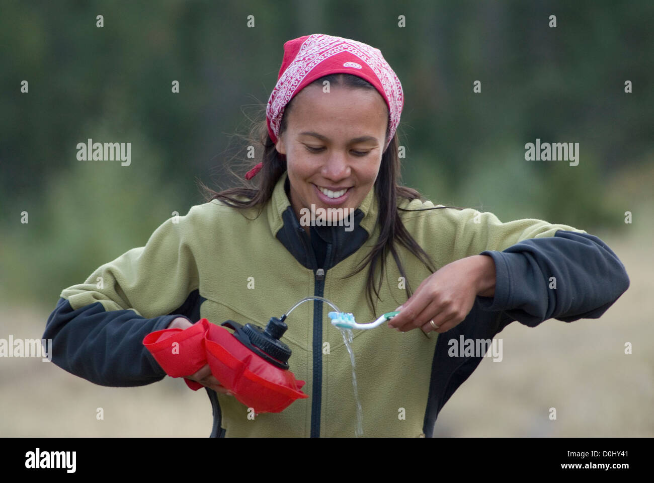 Woman brushing teeth on a backpack trip in Oregon's Wallowa Mountains ...