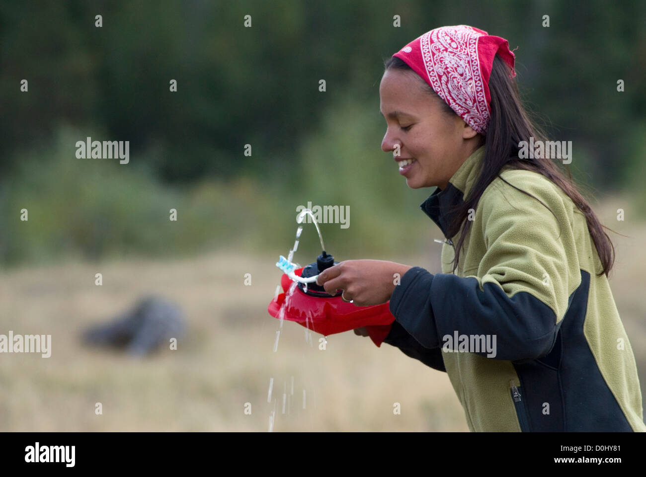 Woman brushing teeth on a backpack trip in Oregon's Wallowa Mountains ...