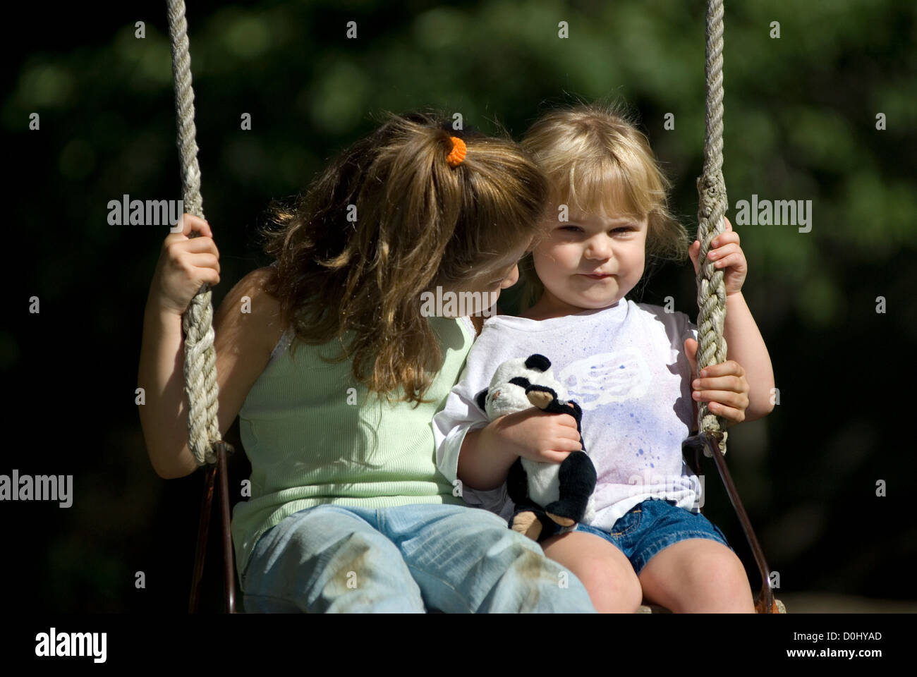 Sisters on a swing hi-res stock photography and images - Alamy