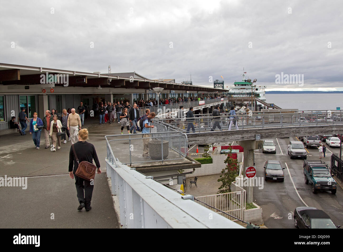 Passengers and vehicles disembark ferry at ferry terminal, Seattle ...
