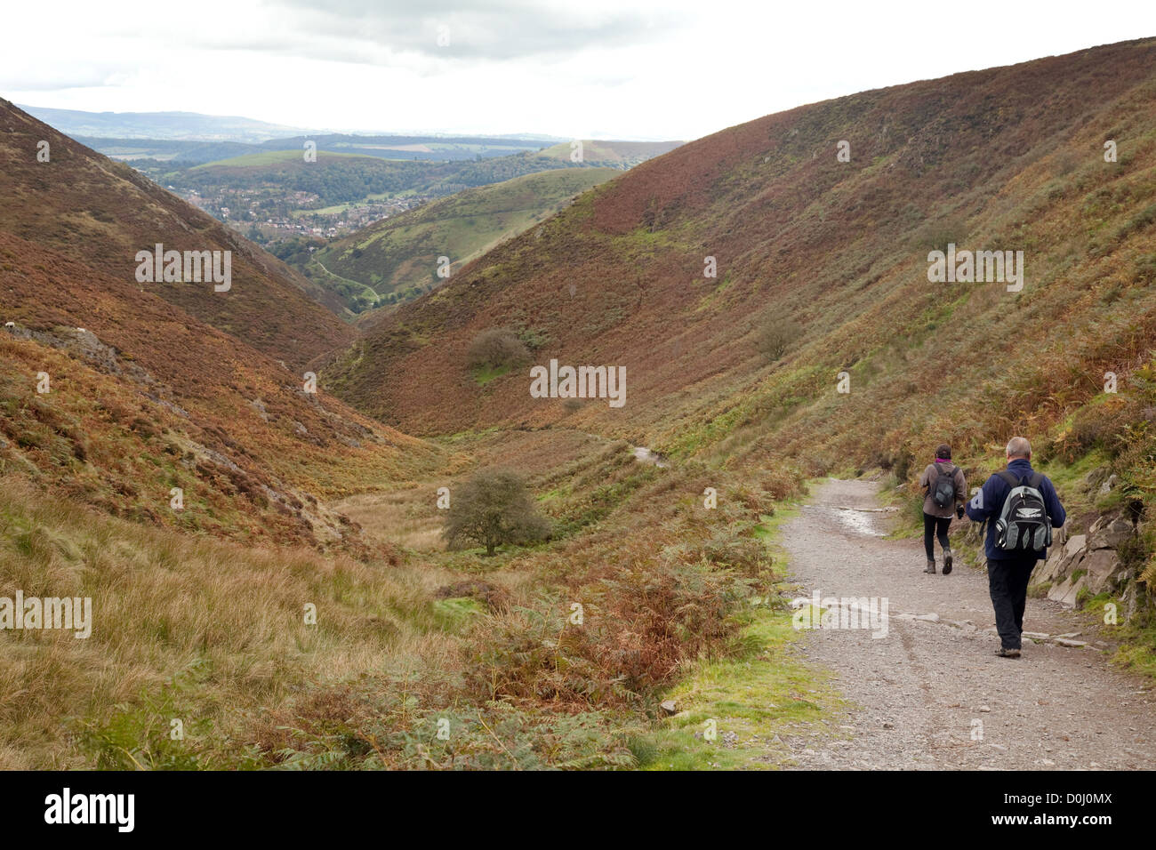 A couple walking on the Long Mynd, Church Stretton in the distance ...