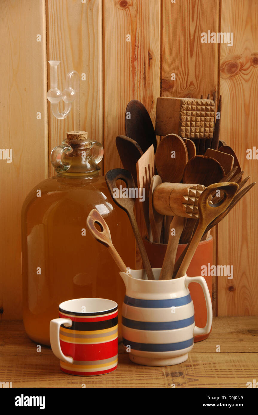Wooden kitchen utensils in a blue striped jug UK Stock Photo - Alamy