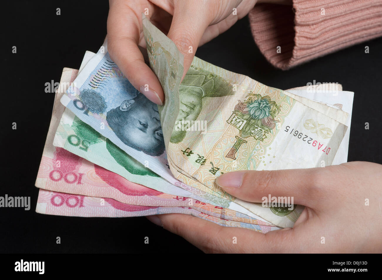 Female's hand holding Chinese banknotes Stock Photo - Alamy