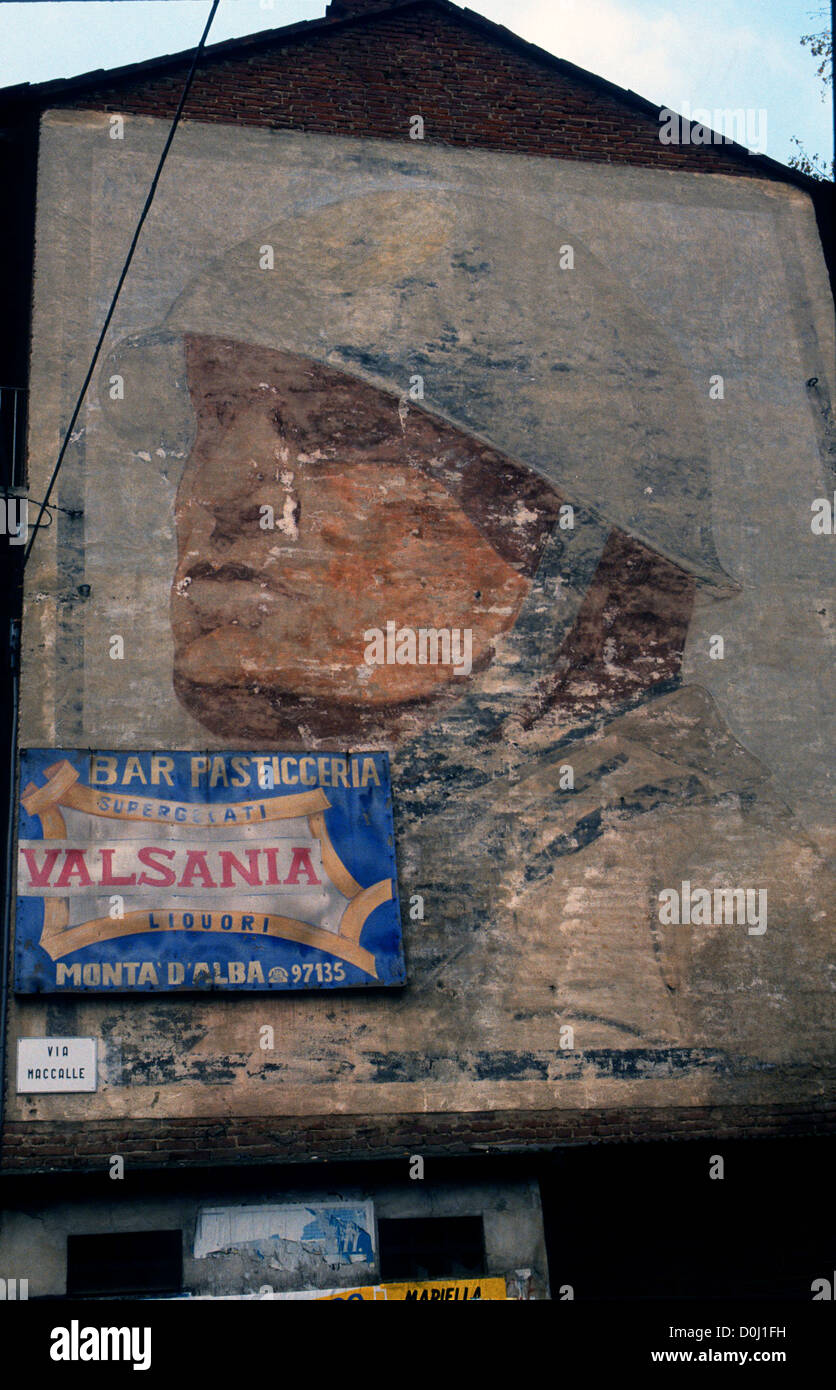 A FADED WALL PAINTING OF MUSSOLINI ON THE GABLE OF A HOUSE IN ALBA ...
