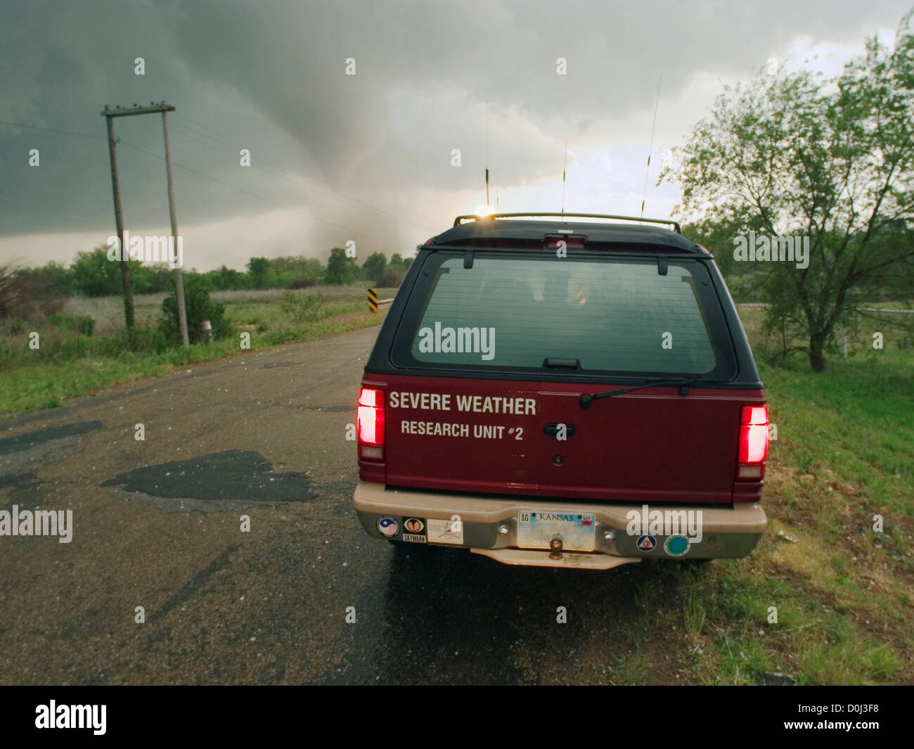 Storm Chasers Watch a Large Tornado From the Safety of Their Vehicle ...