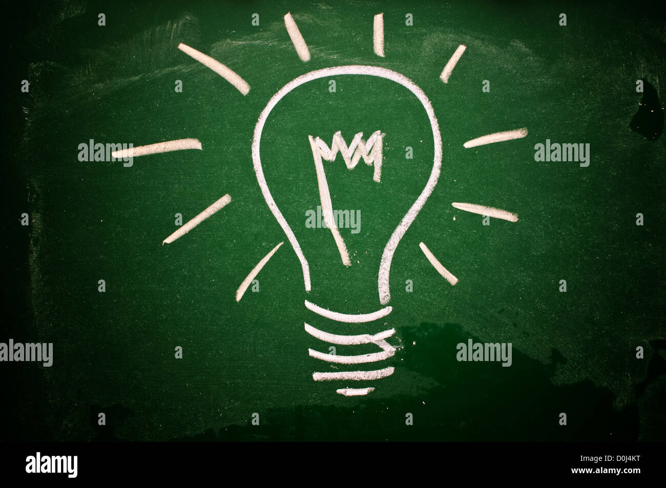 A light bulb drawn on a green chalkboard symbolizing ideas, inspiration ...
