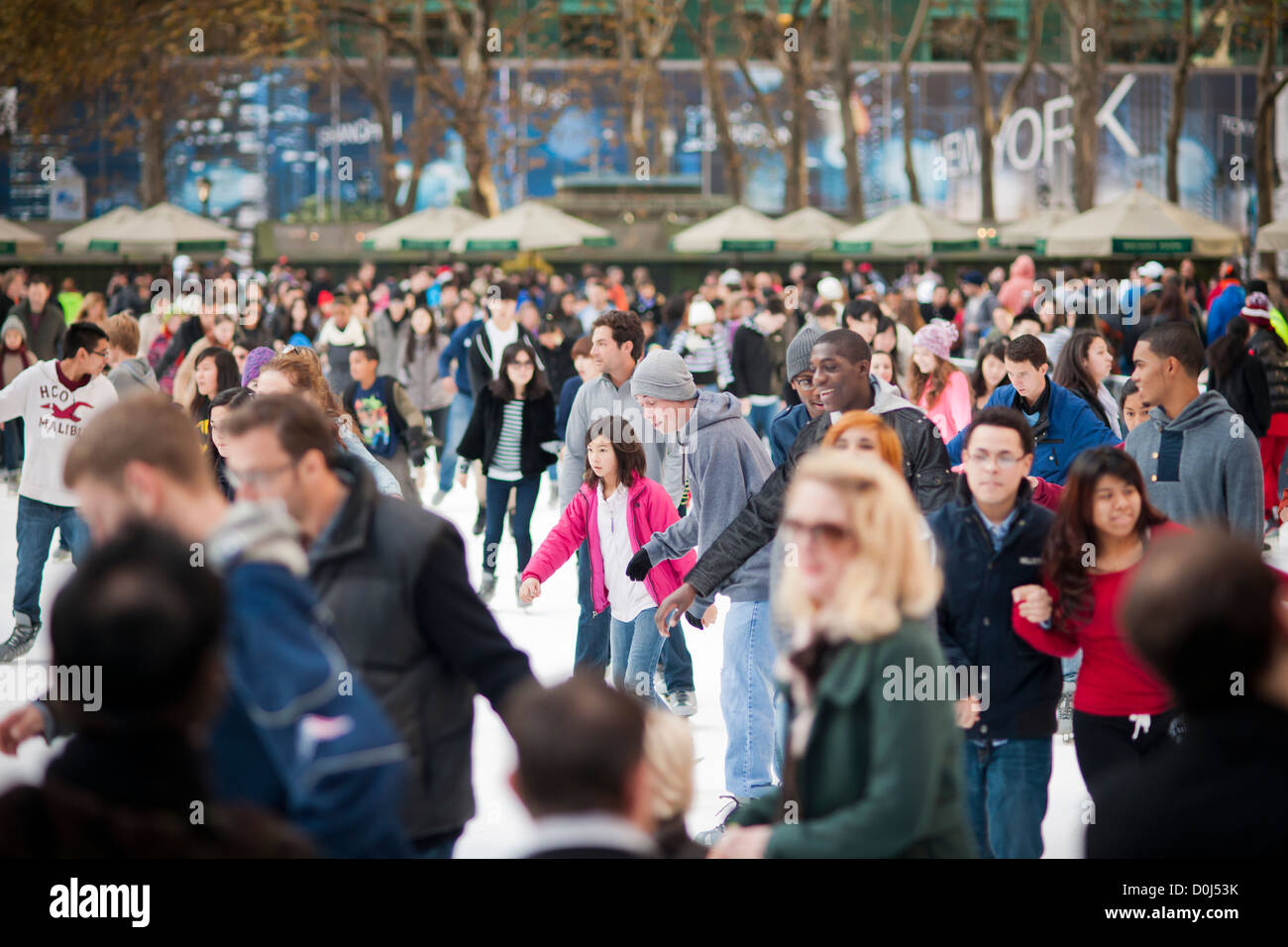 Skaters maneuver the packed Pond at Bryant Park ice skating rink in New ...