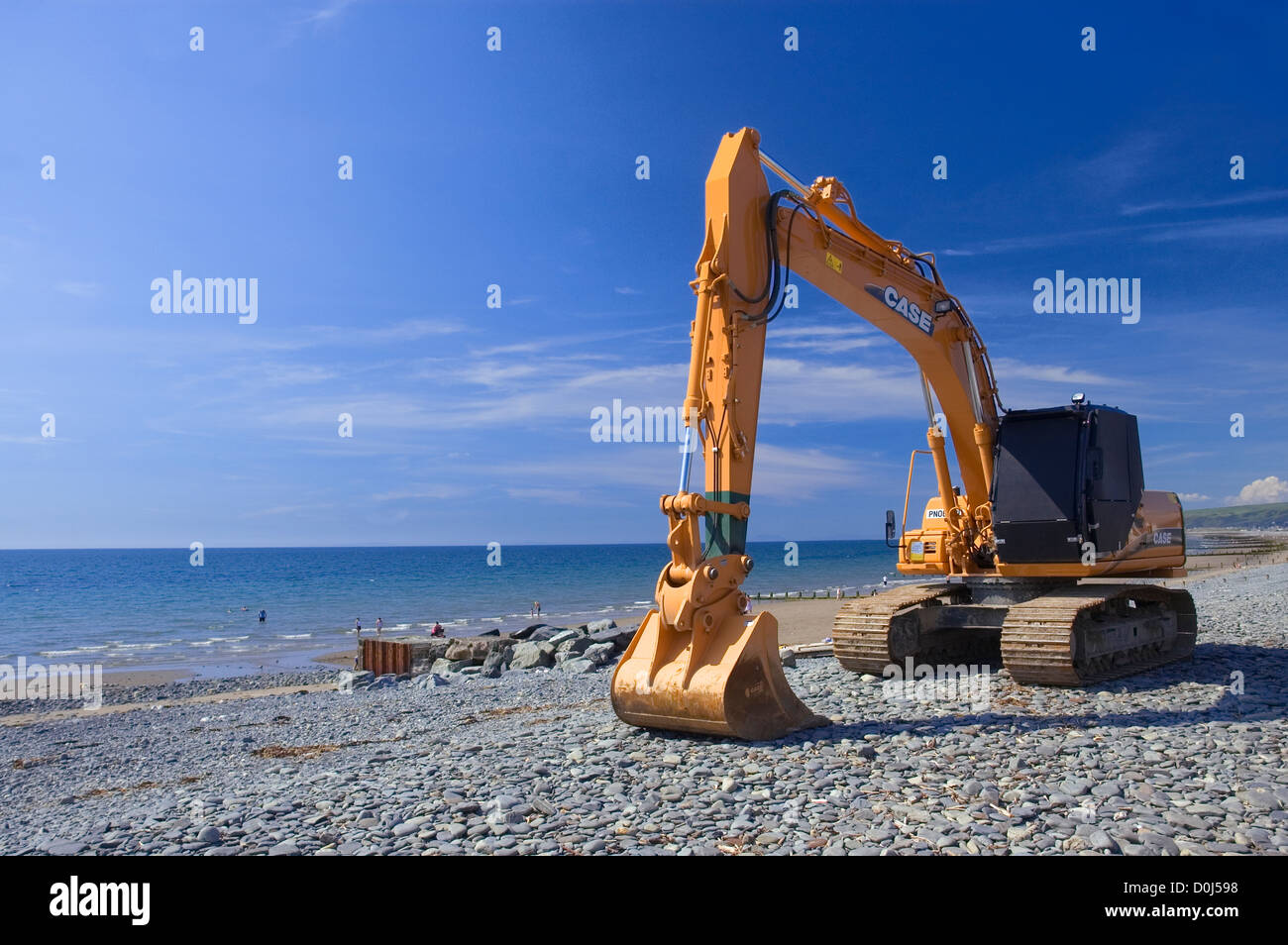 A mechanical digger on the beach at Borth Stock Photo - Alamy