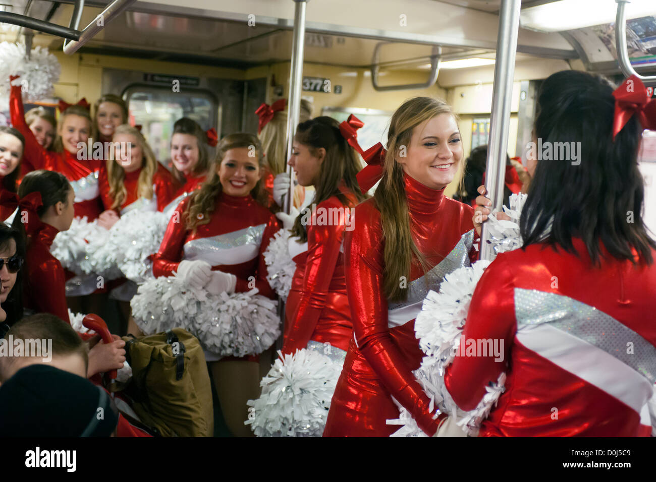 Members of the Varsity Spirit cheerleading team, travel via the subway ...