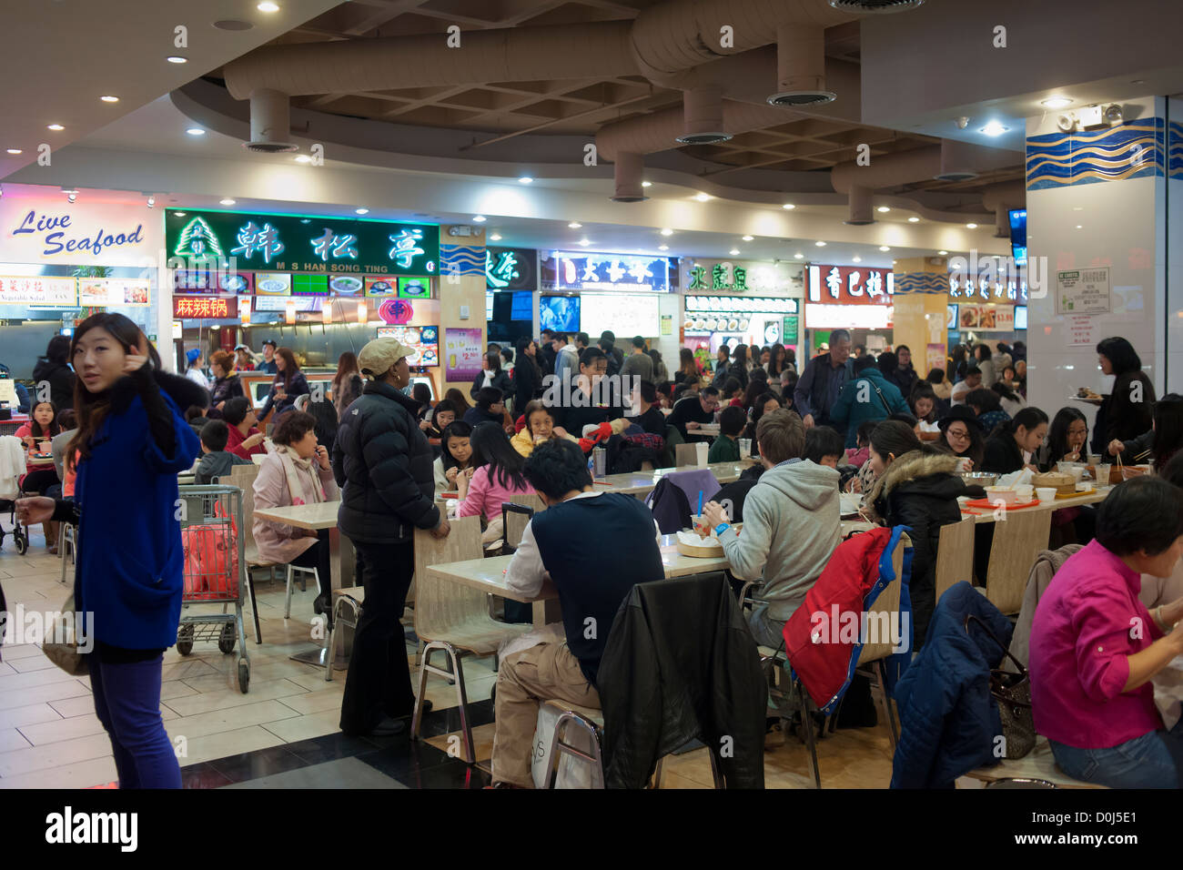 Diners in the busy food court of the New World Mall in the Flushing ...